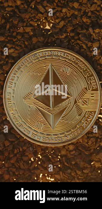 Vertical video. A Pair of Fingers Takes Away the Ethereum Coin and ...