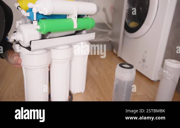 Hands Using a Wrench to Unscrew the Filter Housing Bulb of the Reverse ...