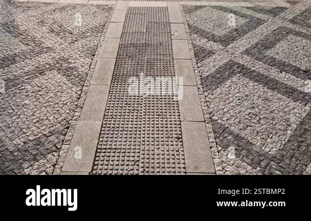 ripples pattern from mosaic cubes on black rough pavement. squares and ...
