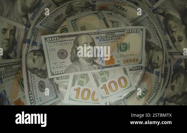 Close-Up View of a Hand Moving Hundred-Dollar Bills Inside a Glass Jar ...