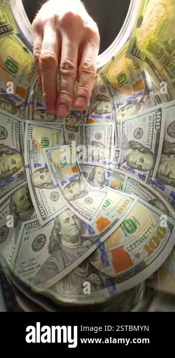 Vertical video. Close-Up View From Inside a Jar as a Hand Shuffles ...