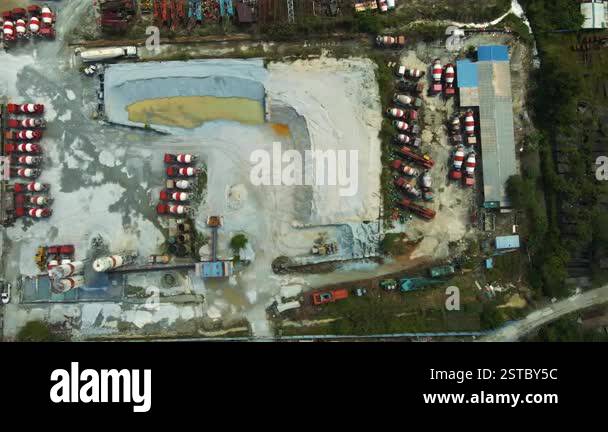 Aerial 4K view of a cement and concrete processing plant with silos ...
