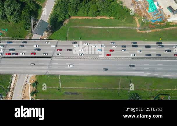 Aerial 4K view of heavy highway traffic. Cars move slowly as people ...