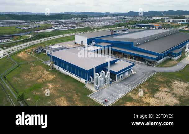 Aerial 4K view of a blue industrial building with ventilation systems ...