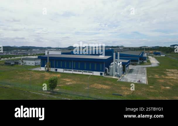 Aerial 4K view of a blue industrial building with ventilation systems ...