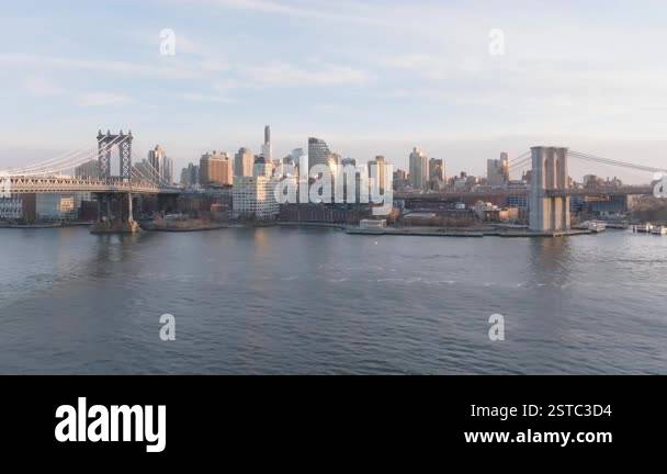 Aerial view of DUMBO, Brooklyn. Shot along the East River at sunset ...