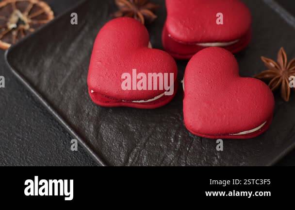 Red macaroons in the shape of a heart, sweets for the holiday of ...