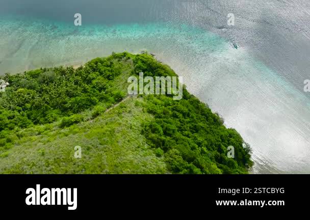 Coastal peninsula bordered by calm turquoise waters and lush tropical ...