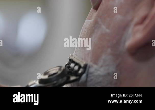 Close-up view of a man shaving his neck with sharp manual trimmer ...