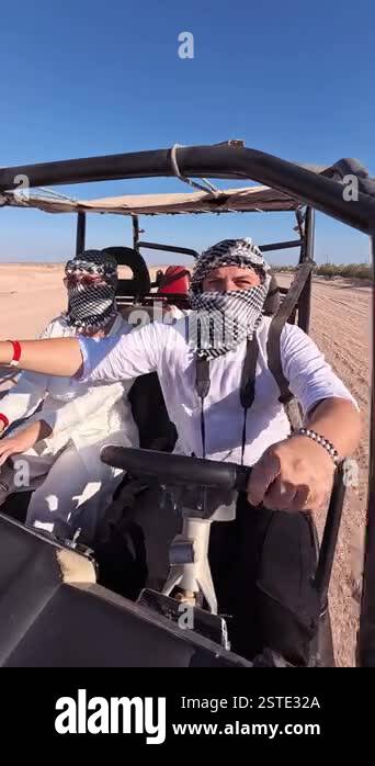 Egyptian activity with off-road vehicles and dust dirt road. Tourists ...