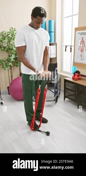A young african american man exercises with resistance bands in a ...