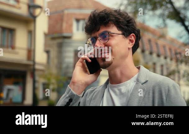 Positive smiling happy business male talking call speaking mobile phone ...