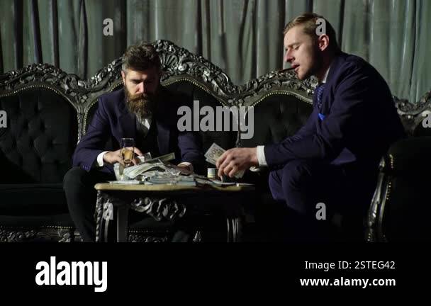 Two rich men. Gangsters in dark room counting money dollars. Rich ...