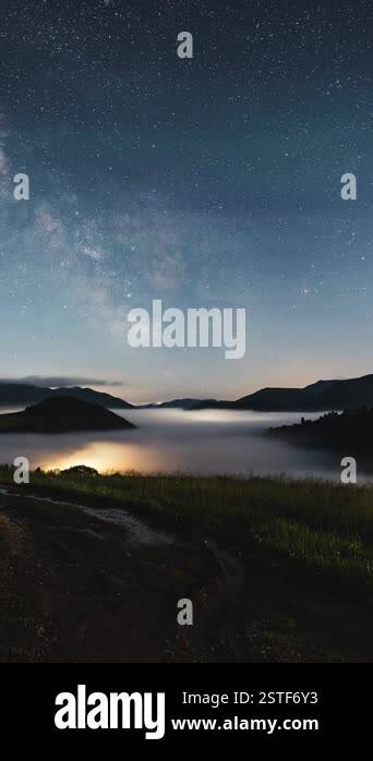 Vertical view of milky way galaxy stars in starry night sky over misty ... Vertical view of milky way galaxy stars in starry night sky over misty ...