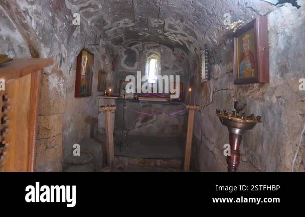 Ancient stone walls and softly glowing candles surrounding religious ...