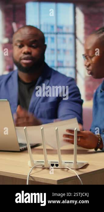 Discouraged African American couple struggles with an unstable Wi Fi ...