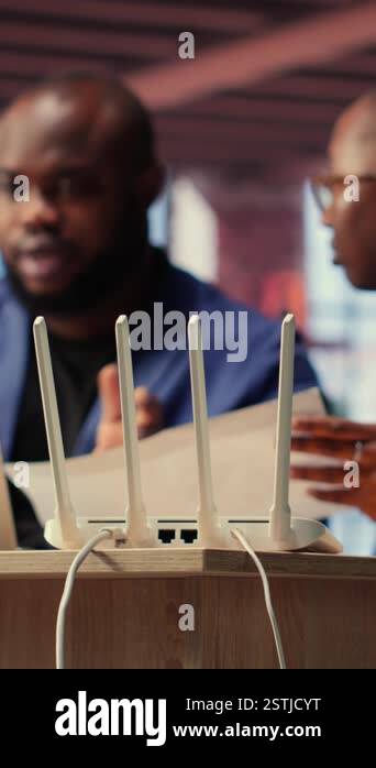 Black irritated man and woman rebooting their wireless router and ...