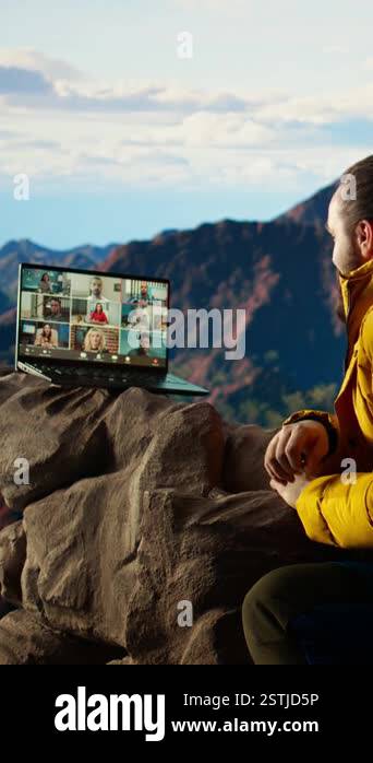 Vertical Video Entrepreneur uses high speed internet connection on mountain top, enjoying the ...