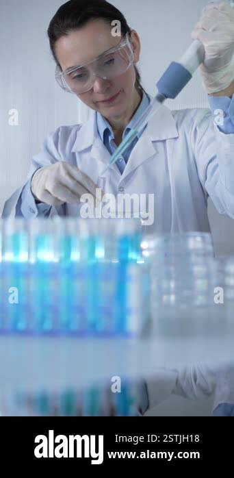 Female scientist wearing lab coat, white medical gloves and protective ...