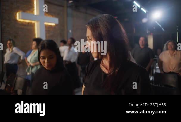 Congregation holding hands in prayer and unity during a heartfelt ...