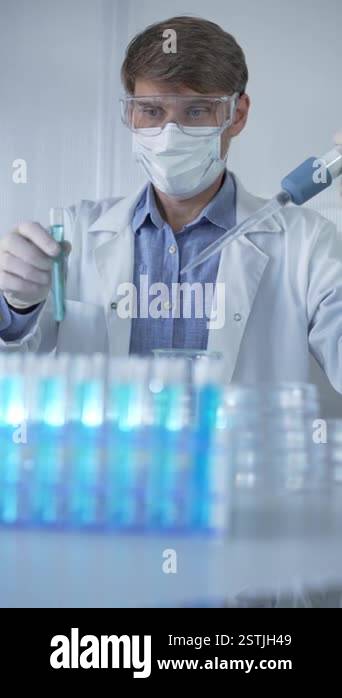 Male scientist researcher, wearing lab coat, white medical gloves, mask ...