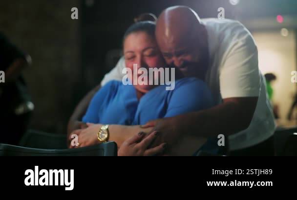 Person of African descent embraces woman in emotional moment of joy and ...