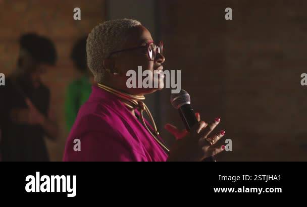 African descent woman preaching passionately during evangelical church ...