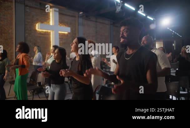 Multicultural congregation clapping and smiling during church worship ...