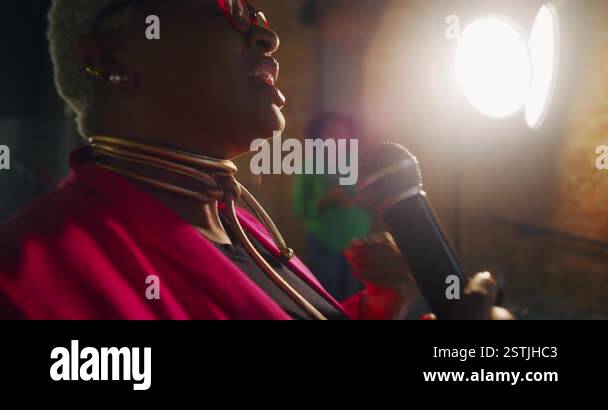 Close-up of a woman passionately singing into a microphone during a ...