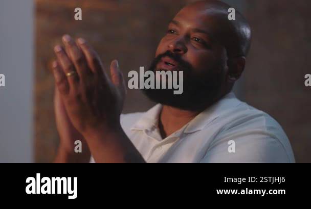Man lifting hands and clapping in worship, African American man in ...