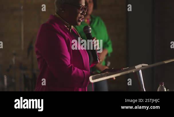 African descent woman preaching passionately during evangelical church ...