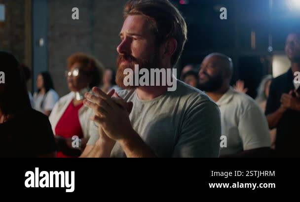 Man deeply immersed in prayer during spiritual worship, holding hands ...