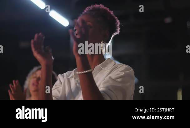 Woman clapping hands in worship, emotional expression of faith ...