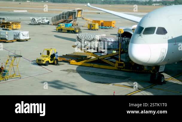 Qatar Airways loading luggage airplane airport runway people working at ...