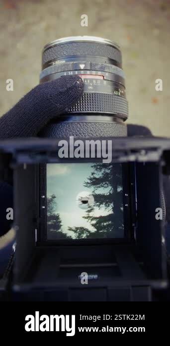 Captured from a first-person view, a photographer walks through a quiet ...
