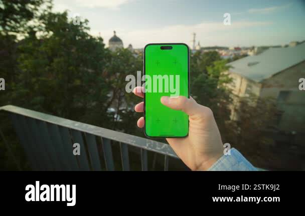 Horizontal shooting of mans hand holding phone with green screen ...
