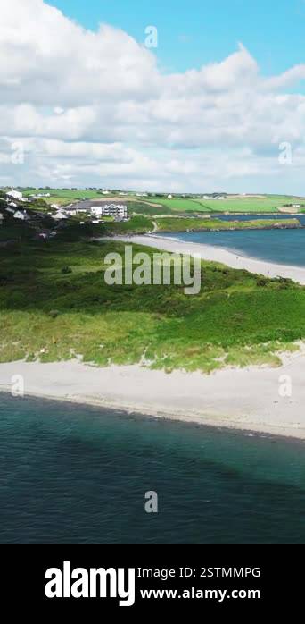 An aerial video of a sandy spit separating two bodies of water. The ...