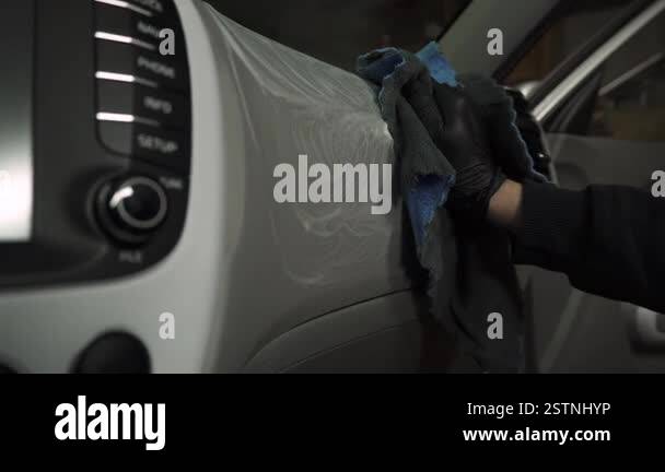 Detailing process 4k video. Worker cleans cars using microfiber cloth to dry the dashboard ...