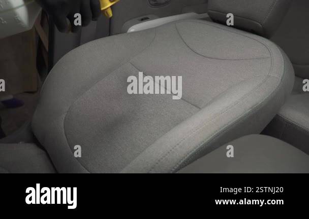 Spraying detergent on textile seats in car interior for dry cleaning 4k ...