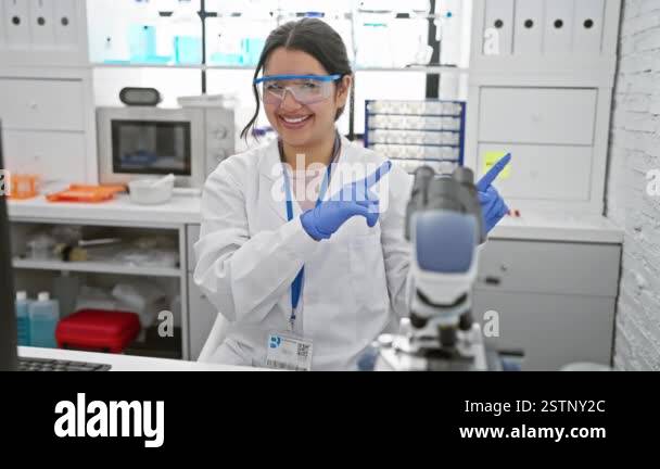 Hello from our lab! lovely young hispanic woman scientist with a ...