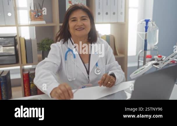 Smiling female doctor with short hair, wearing a white coat and ...