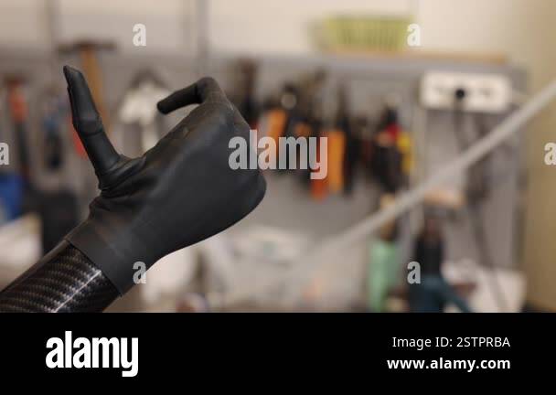 prosthetic hand, carbon fiber, black glove. Close-up view of prosthetic ...