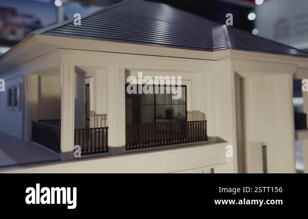 Miniature model of modern house featuring large windows and loggia ...