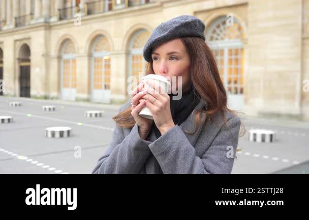 A close-up of a stylish young woman in Paris, wearing a gray beret and ...