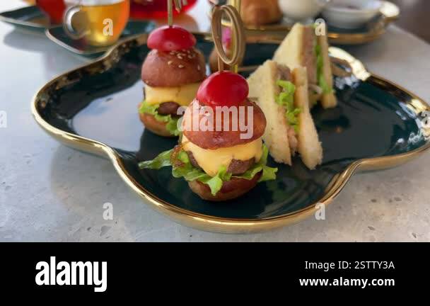 A tray of delicious Beef Sliders is served at a restaurant as a male ...