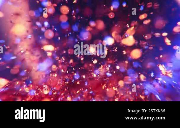 Colorful abstract particles mix glowing in water, glitter under neon ...
