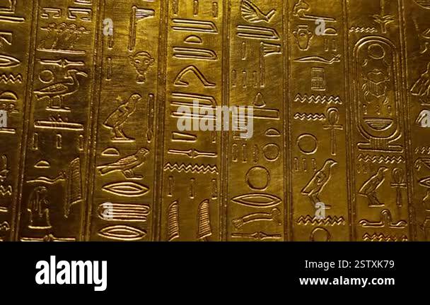 Amazing hieroglyphs carving on golden wall of tomb. Macro view of ...