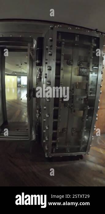 Heavy metal vault door opens slowly, showing an empty room inside Stock ...