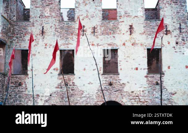 Red flags in front of an ancient castle. Medieval customs and tribal ...