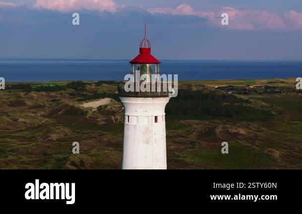 Lyngvig Fyr lighthouse, with its distinctive red top, stands on a hill ...